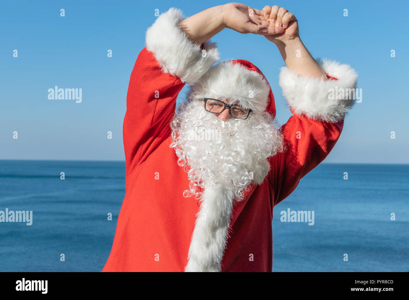 Santa doing exercises on the ocean Stock Photo - Alamy