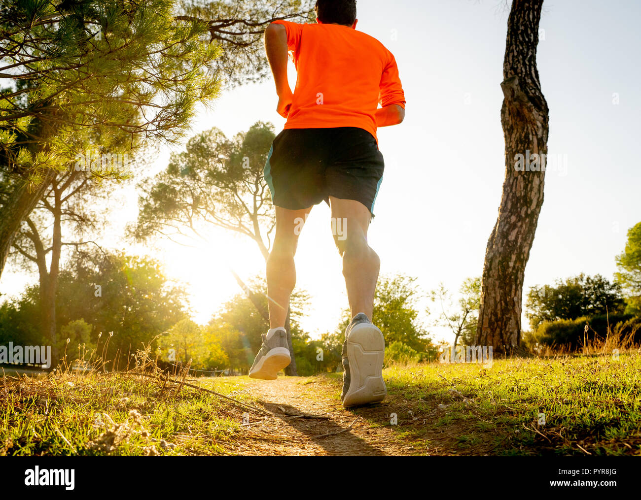 Back view of sport man with ripped athletic and muscular legs running ...