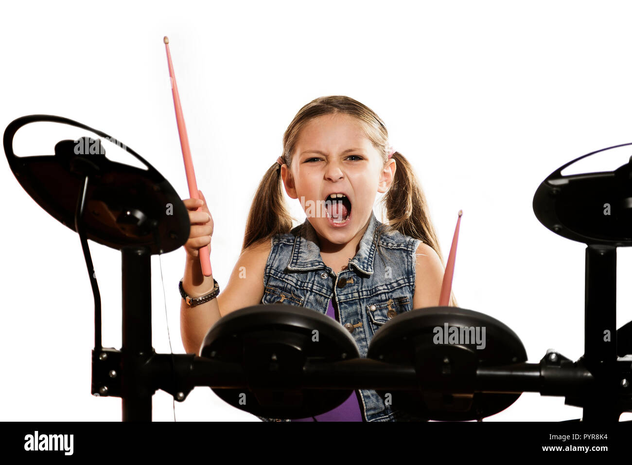 Little caucasian girl drummer playing the elettronic drum kit, close-up ...