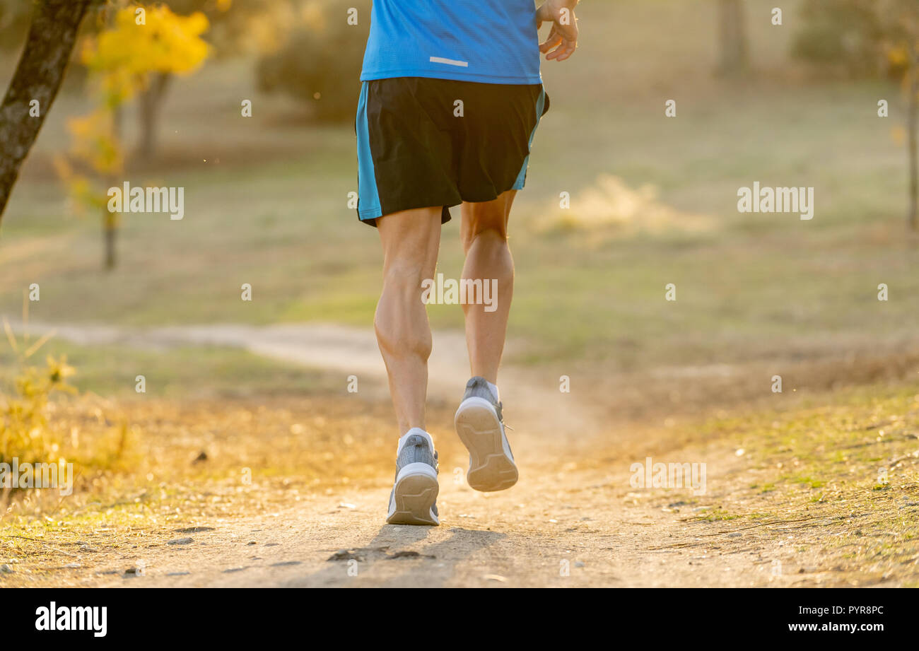 Back view of sport man with ripped athletic and muscular legs running ...