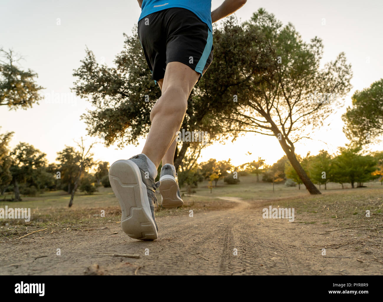 Back view of sport man with ripped athletic and muscular legs running ...