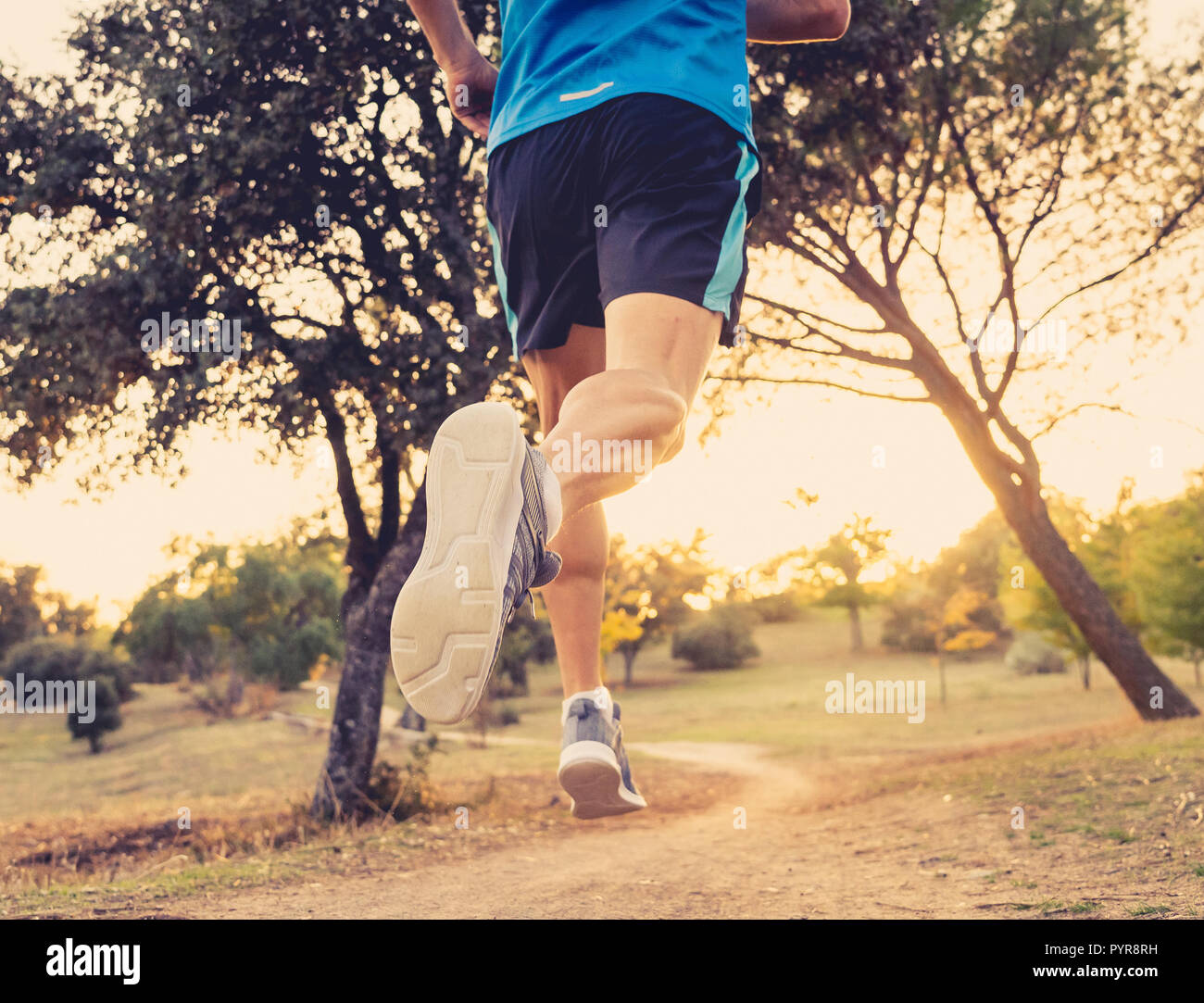 Back view of sport man with ripped athletic and muscular legs running ...