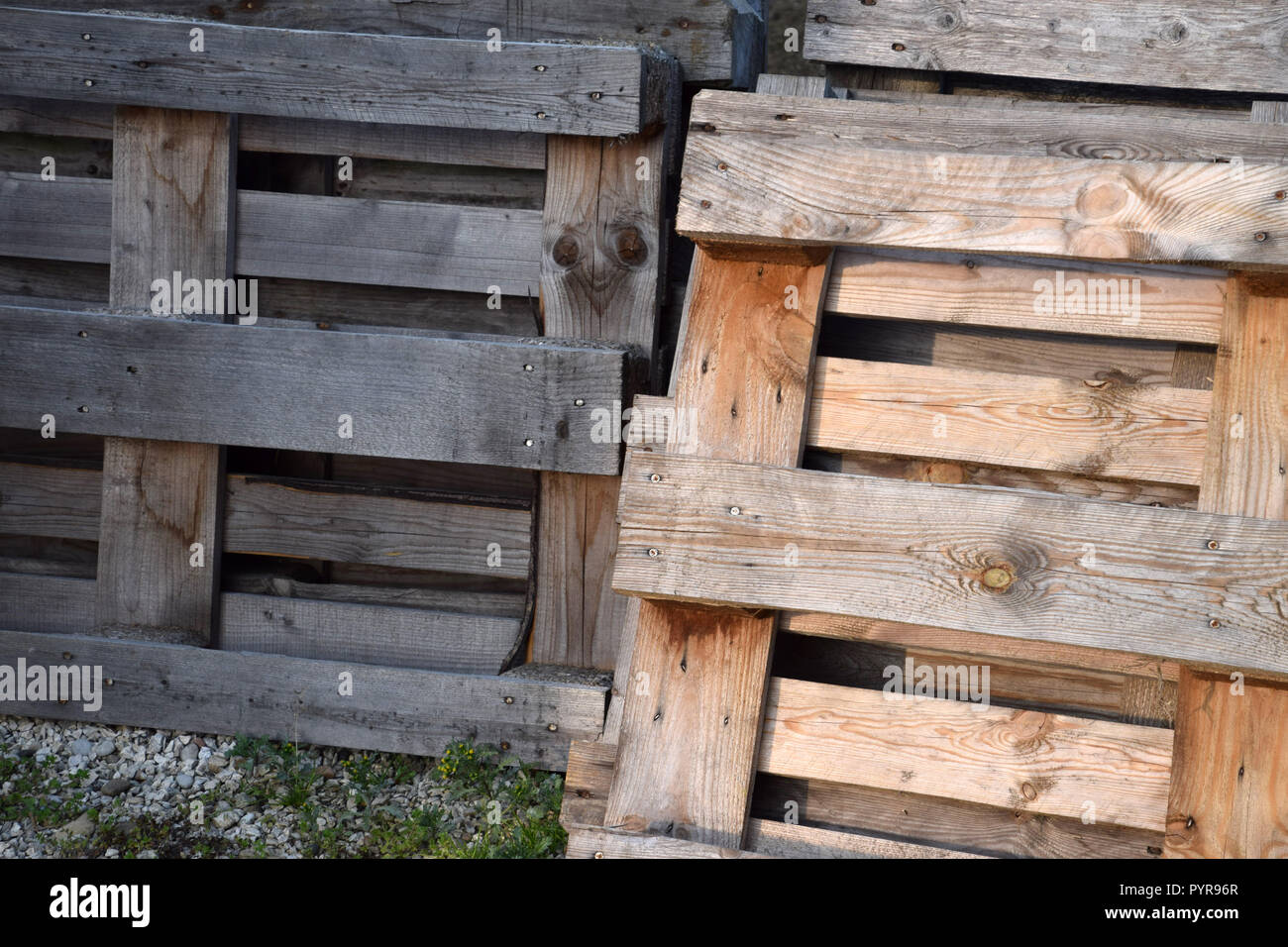 standing stacked wooden pallets, weathered wooden pallets in a row ...