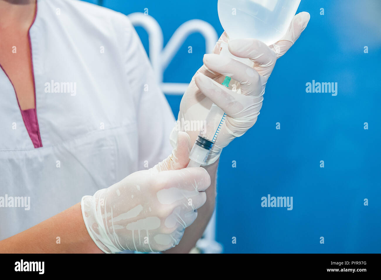 Nurse gaining a syringe for injection in a operating room Stock Photo ...