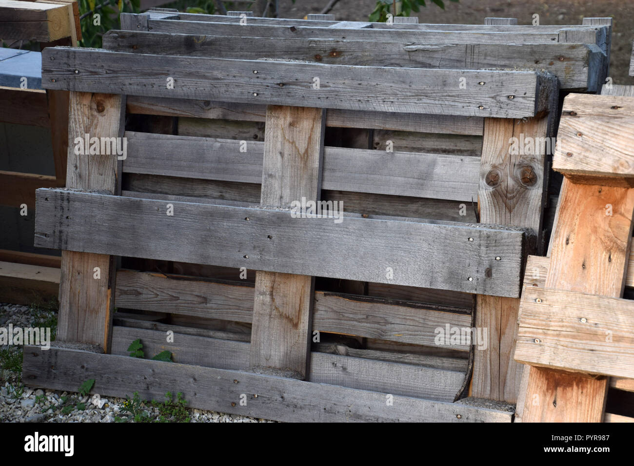 dark gray wooden pallets, weathered wooden pallets in a row stored ...