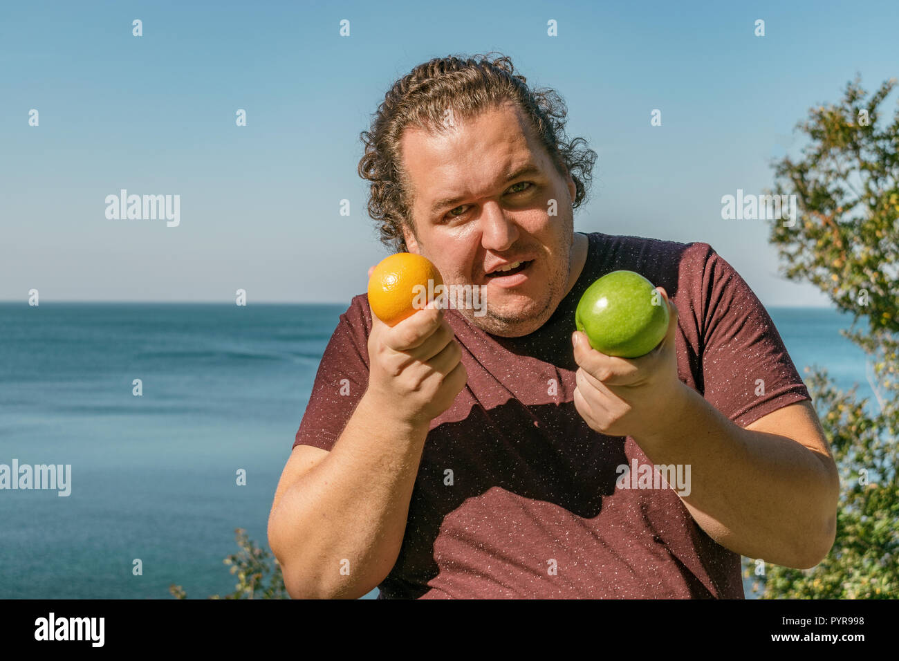 Fat man beach eating hi-res stock photography and images - Alamy