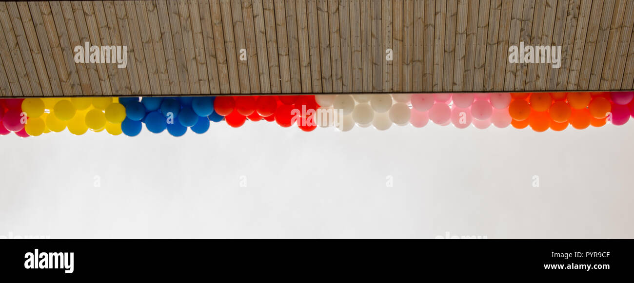 Color balloons on the roof of a building Stock Photo - Alamy