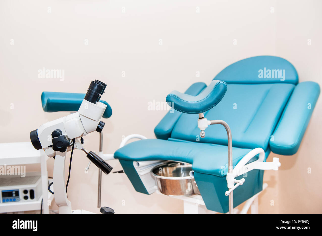 Colposcope and gynecologicalchair in medical centre. Selective focus ...