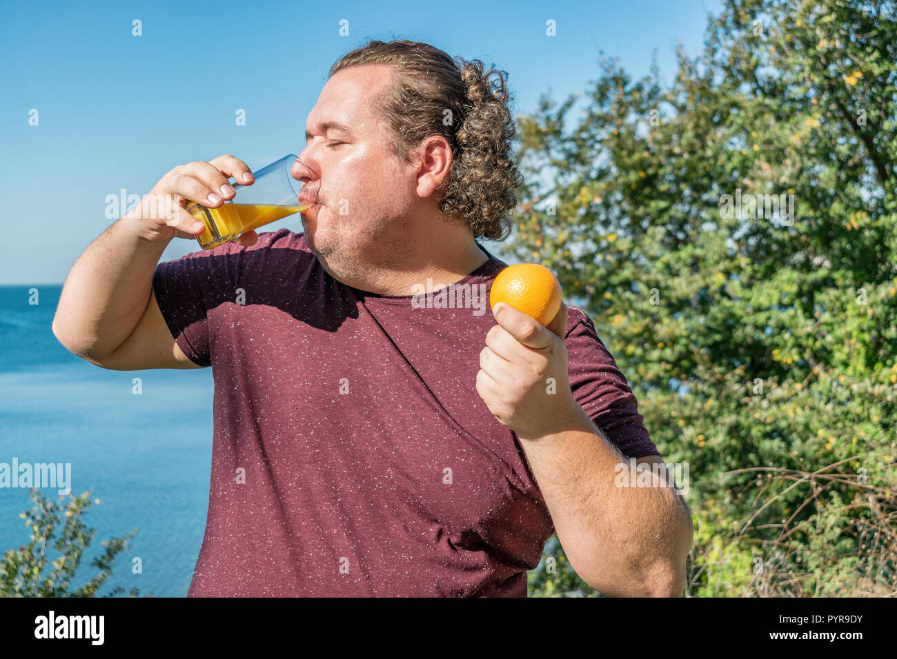 Fat man beach eating hi-res stock photography and images - Alamy