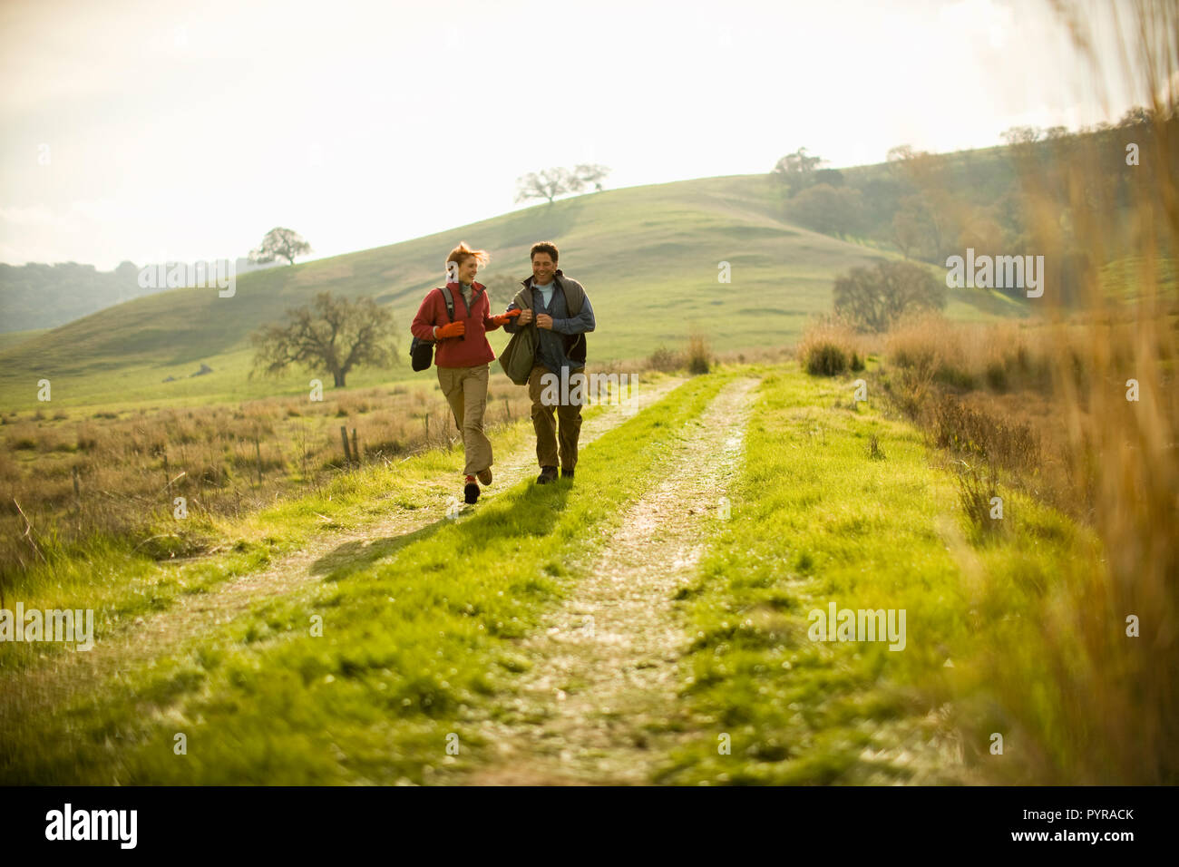 Two women running along road hi-res stock photography and images - Alamy