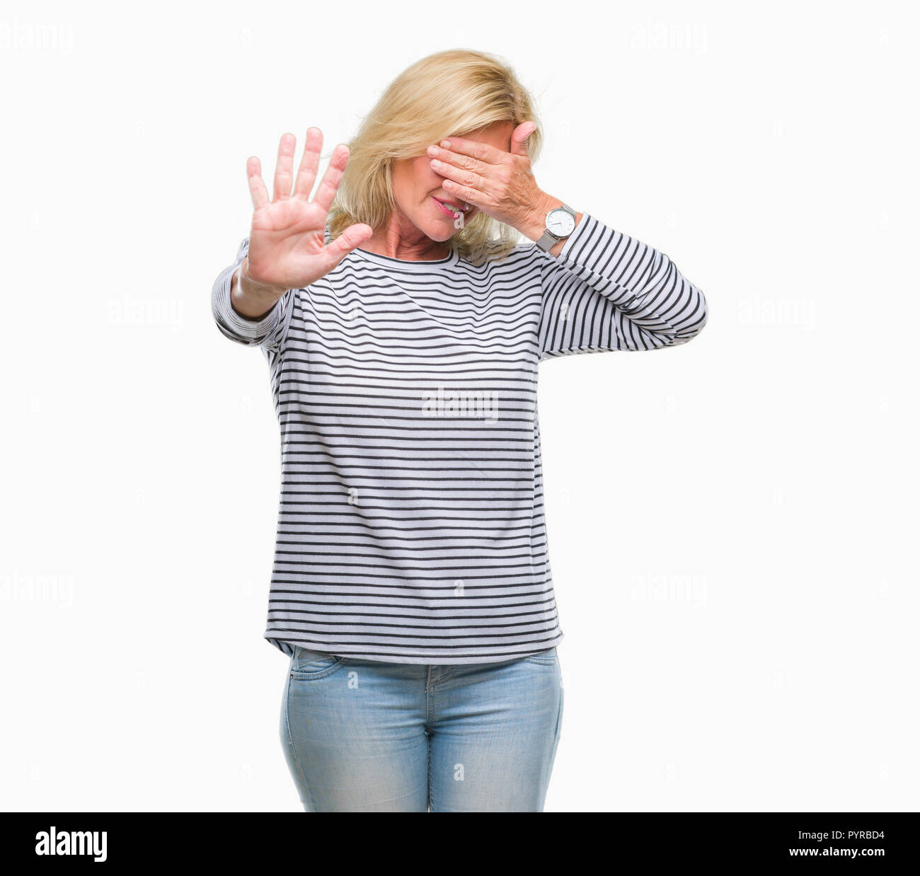 Middle age blonde woman over isolated background covering eyes with ...