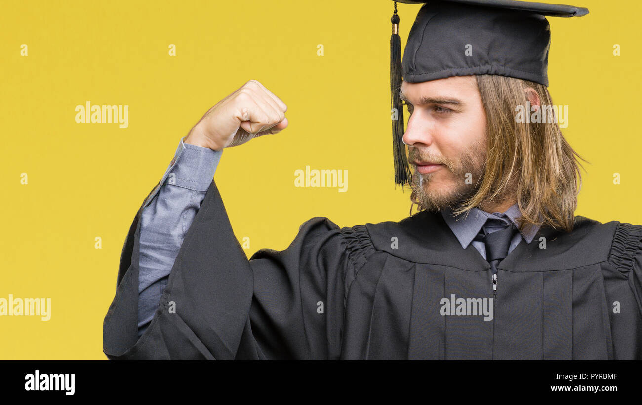 Young handsome graduated man with long hair over isolated background ...