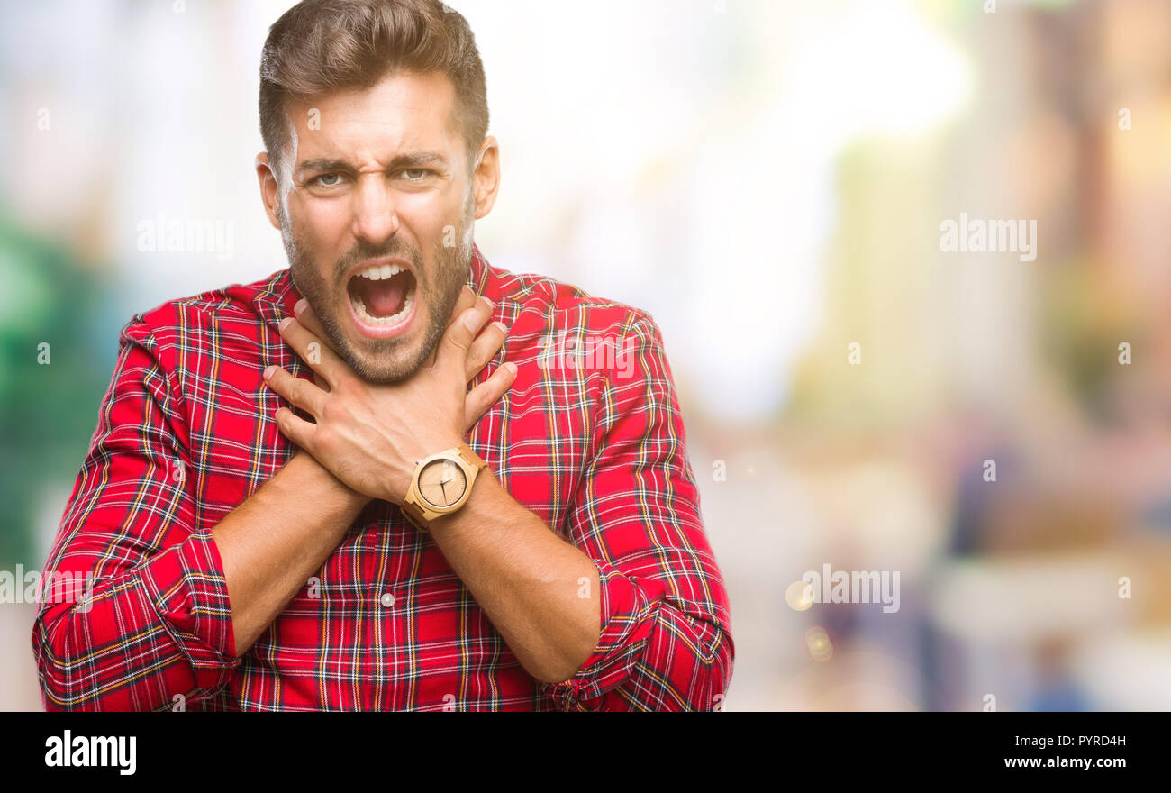 Young handsome man over isolated background shouting and suffocate ...
