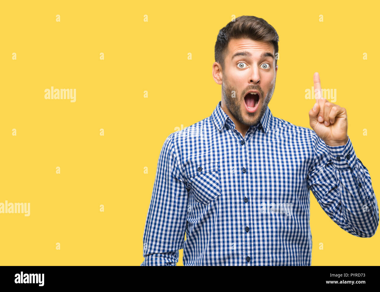 Young handsome man over isolated background pointing finger up with ...