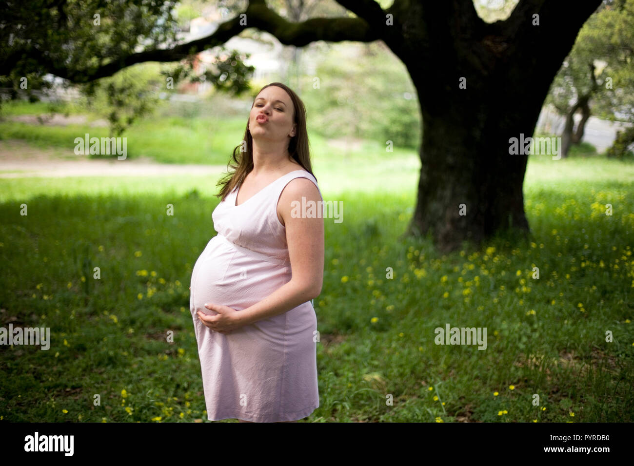 View of a pregnant woman pouting Stock Photo - Alamy