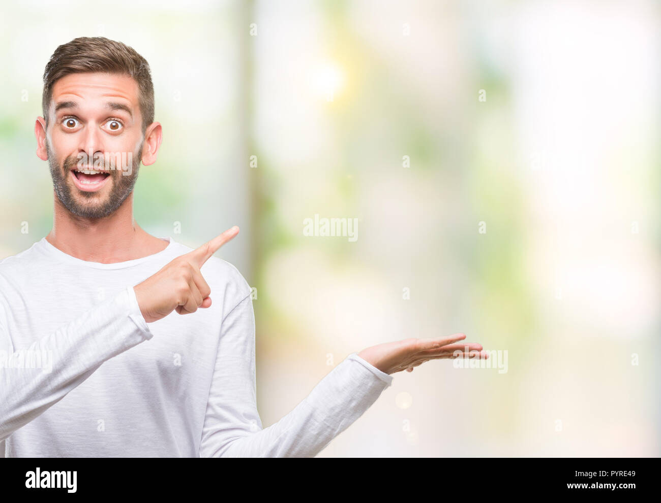 Young handsome man over isolated background amazed and smiling to the ...