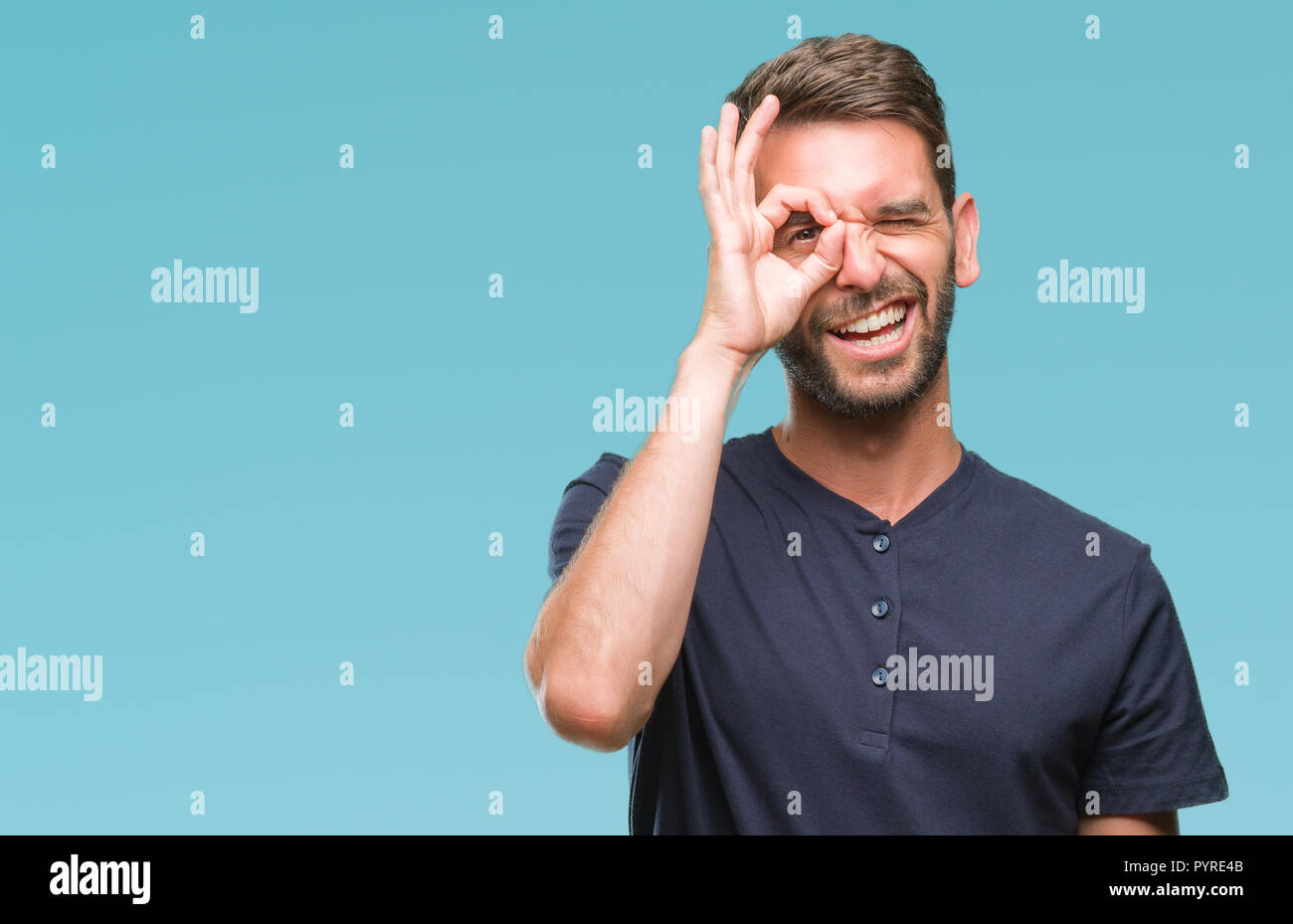 Young handsome man over isolated background doing ok gesture with hand ...