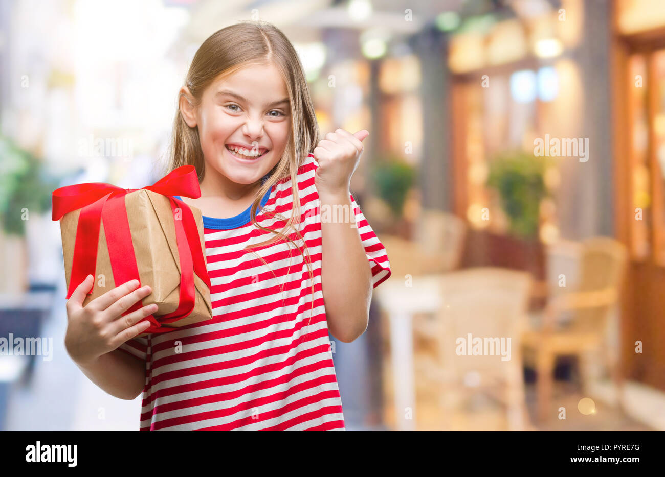 Young beautiful girl giving christmas or valentine gift over isolated ...