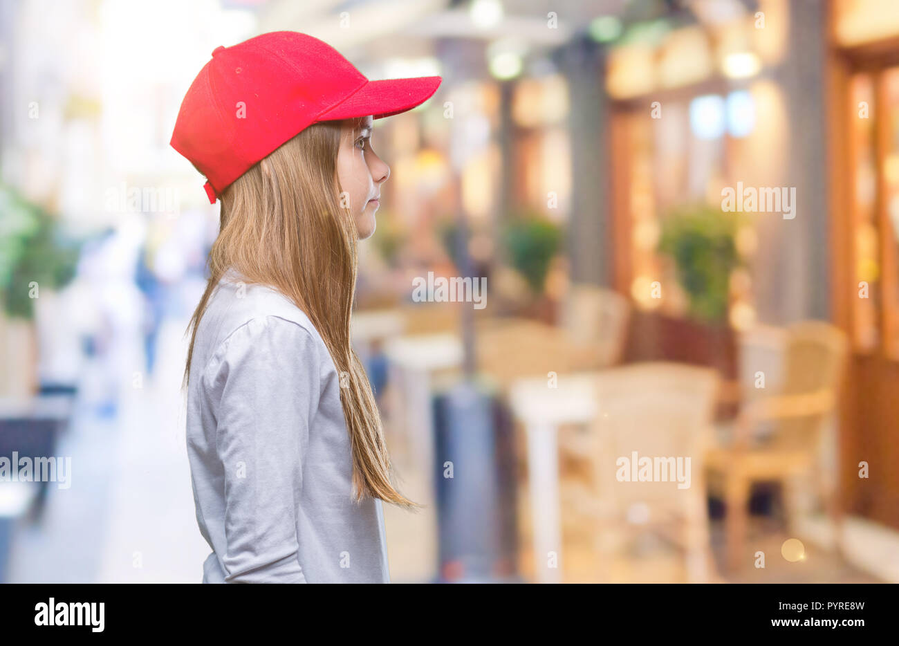 Young beautiful girl wearing red cap isolated background looking to ...