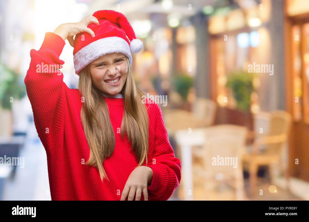 Young beautiful girl wearing christmas hat over isolated background ...