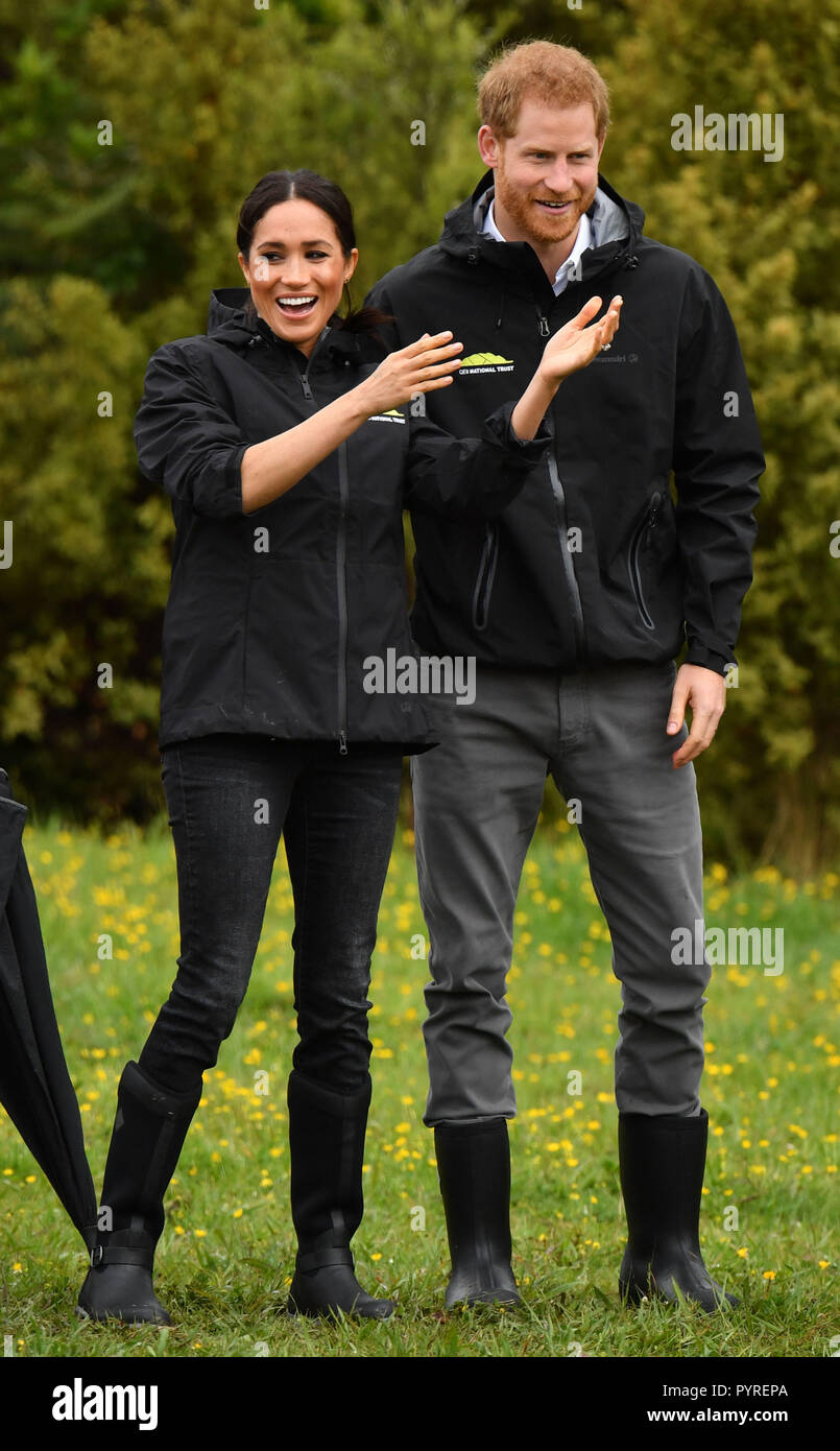 The Duke and Duchess of Sussex, laugh after taking part in a 'wellie ...