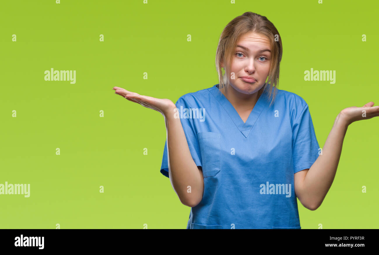 Young caucasian nurse woman wearing surgeon uniform over isolated ...