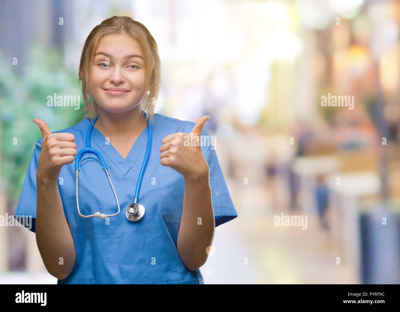 Young caucasian doctor woman wearing surgeon uniform over isolated ...