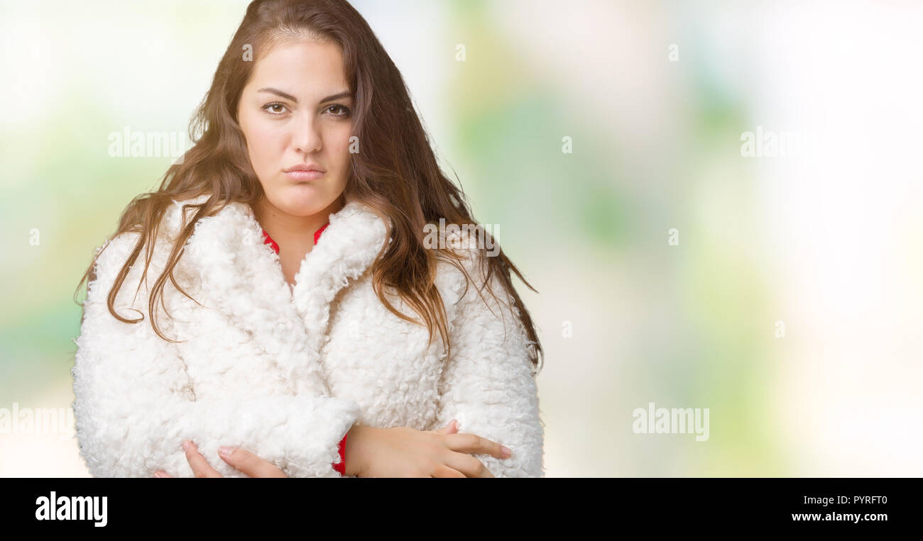 Beautiful plus size young woman wearing winter sheep coat over isolated ...
