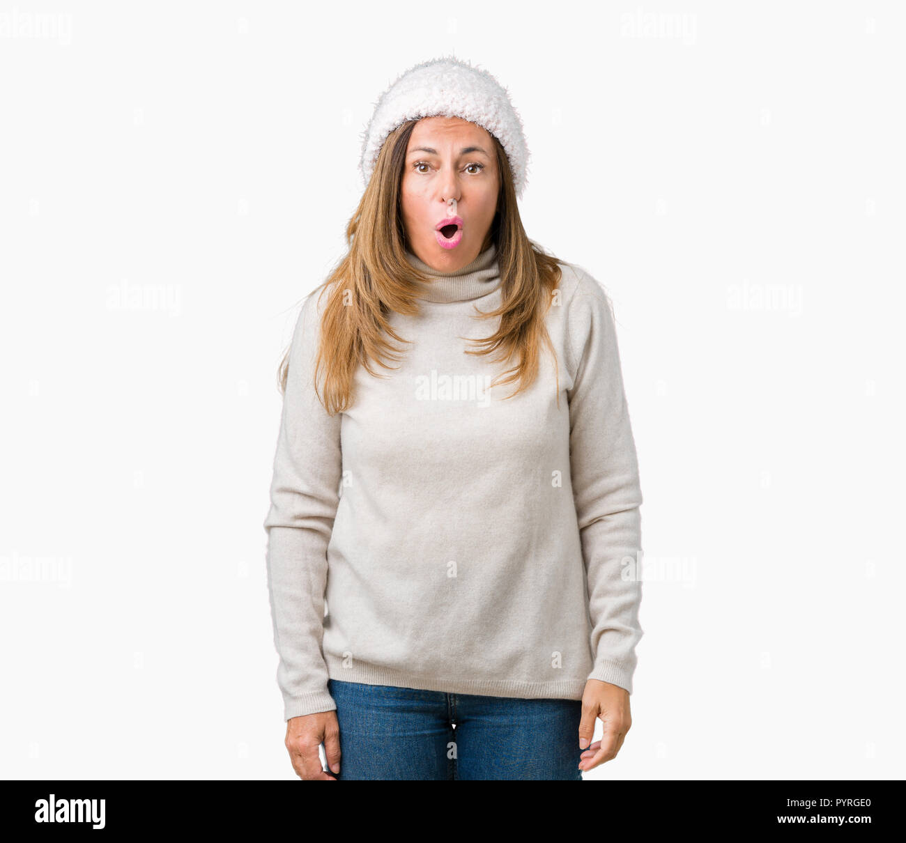 Beautiful middle age woman wearing winter sweater and hat over isolated ...