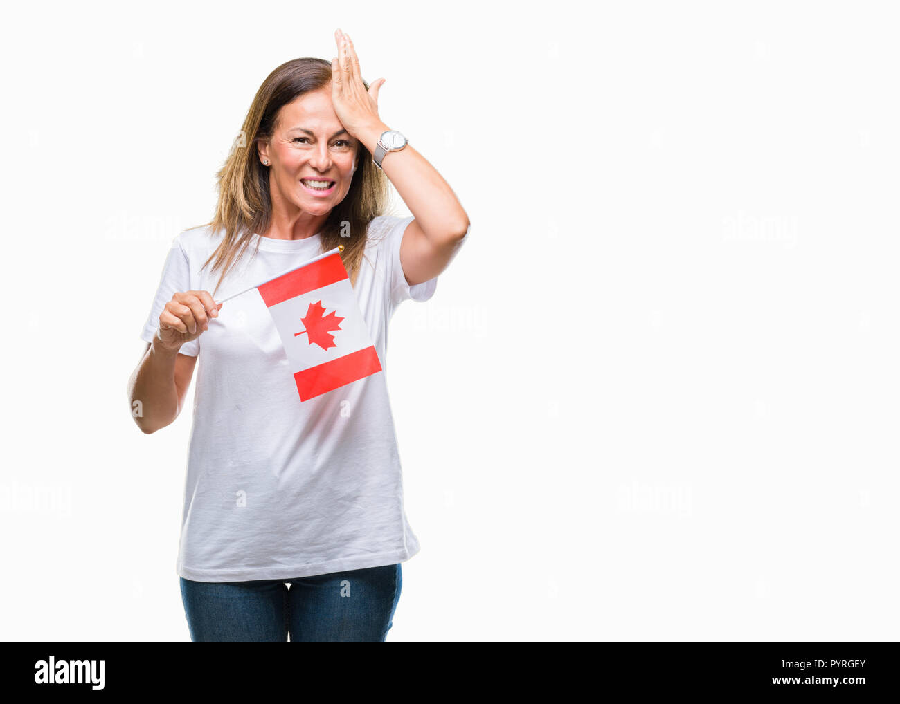 Middle age hispanic woman holding flag of Canada over isolated ...