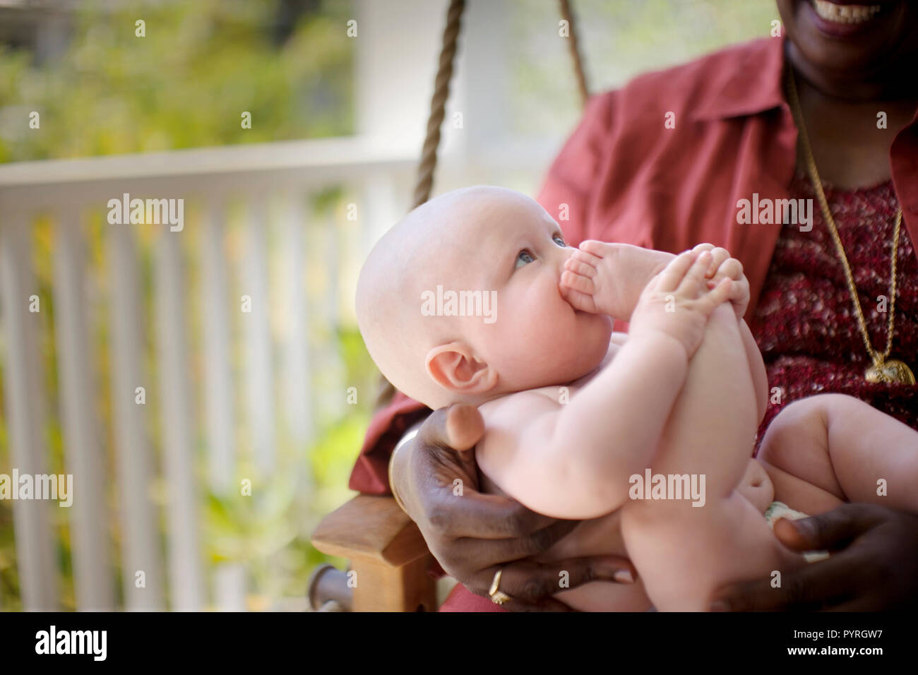 Smiling baby being held aloft by his grandmother Stock Photo - Alamy
