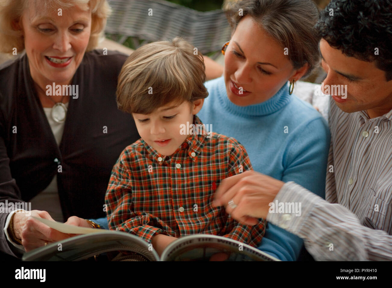 Family reading story together Stock Photo - Alamy