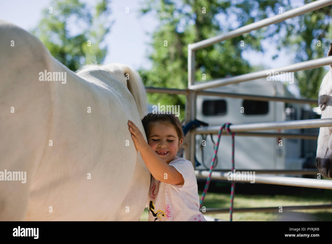 Young girl hugging a horse on a farm Stock Photo - Alamy