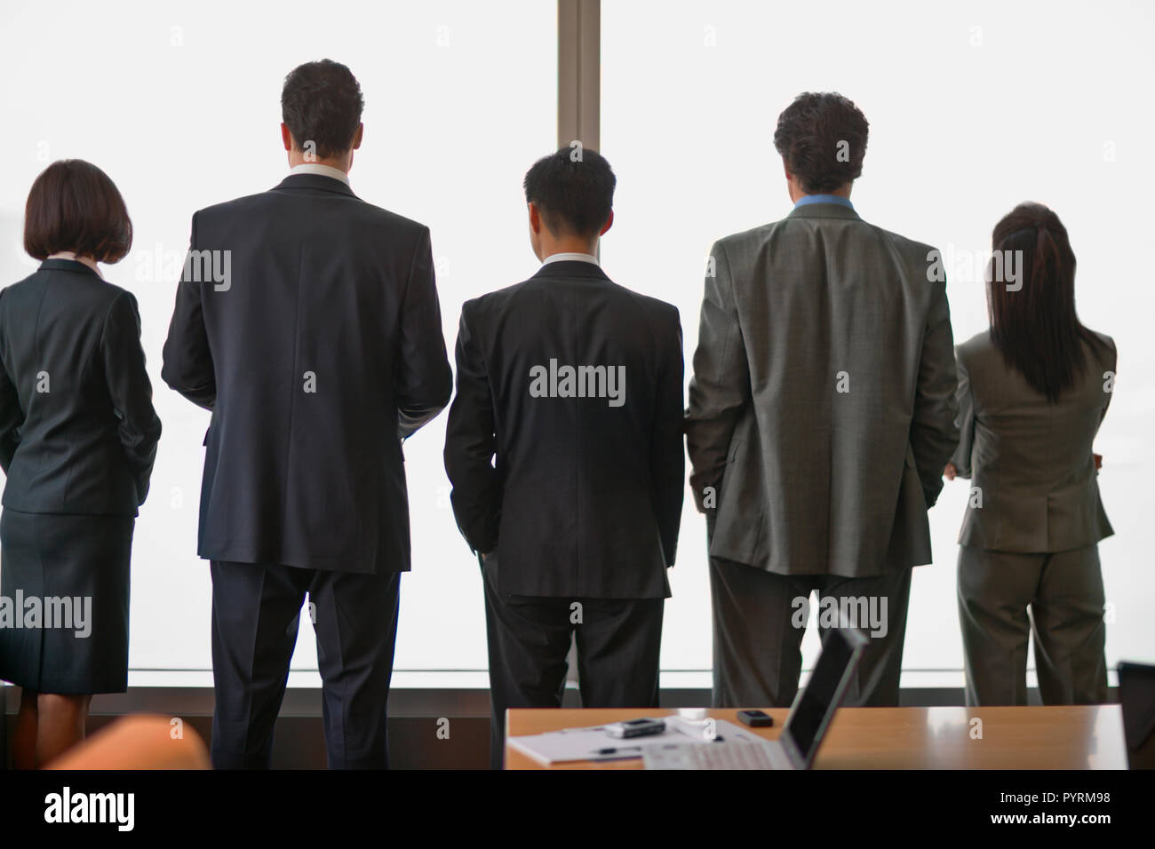 Group of people looking through the window of an office building Stock ...
