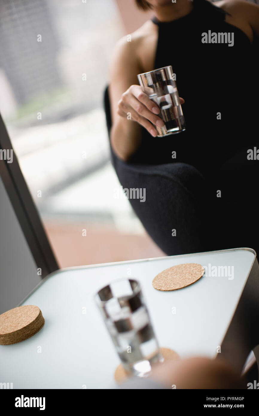 Water glass held by a woman Stock Photo - Alamy