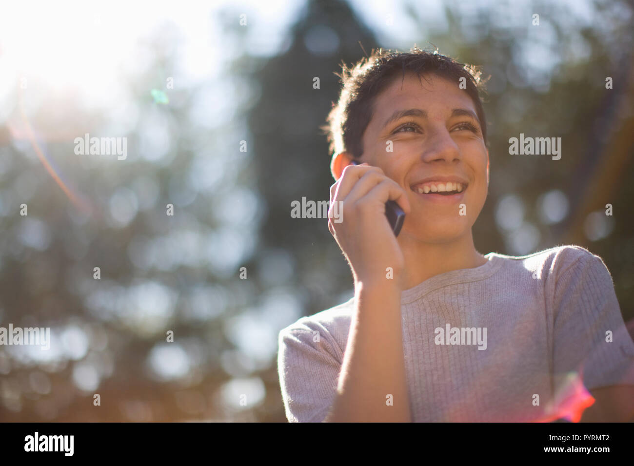 Boy talking outside on cellphone Stock Photo - Alamy