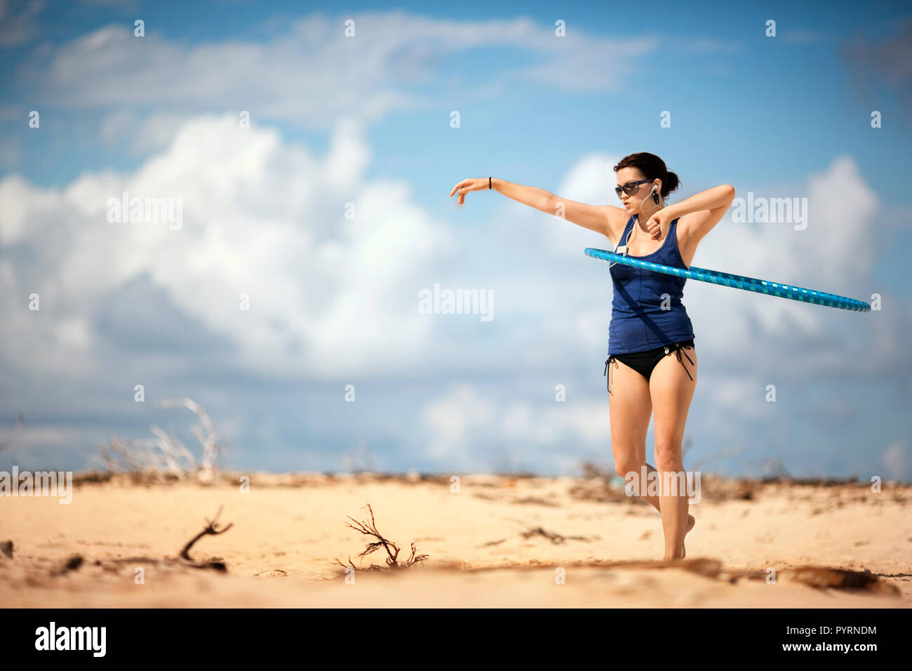 Young woman using a hula hoop at the beach Stock Photo - Alamy