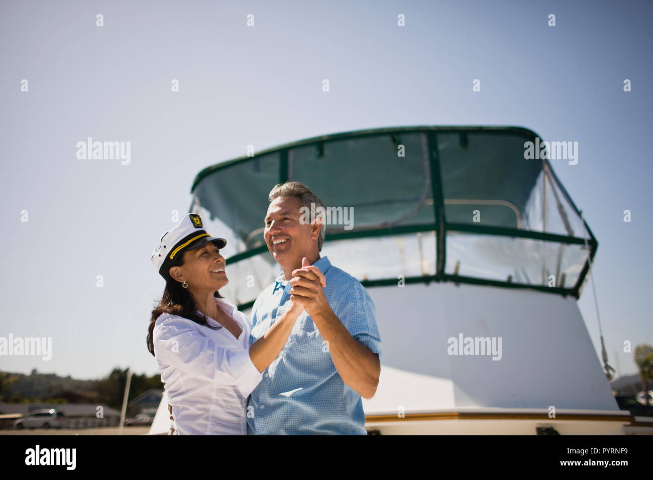 Husband and wife holding hands happily in front of a boat Stock Photo ...