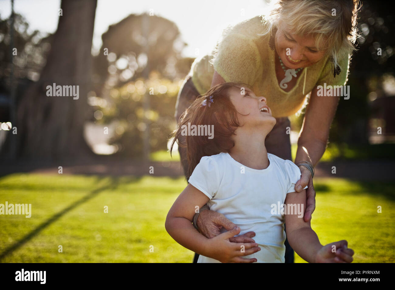 Mother with arms around daughter Stock Photo - Alamy