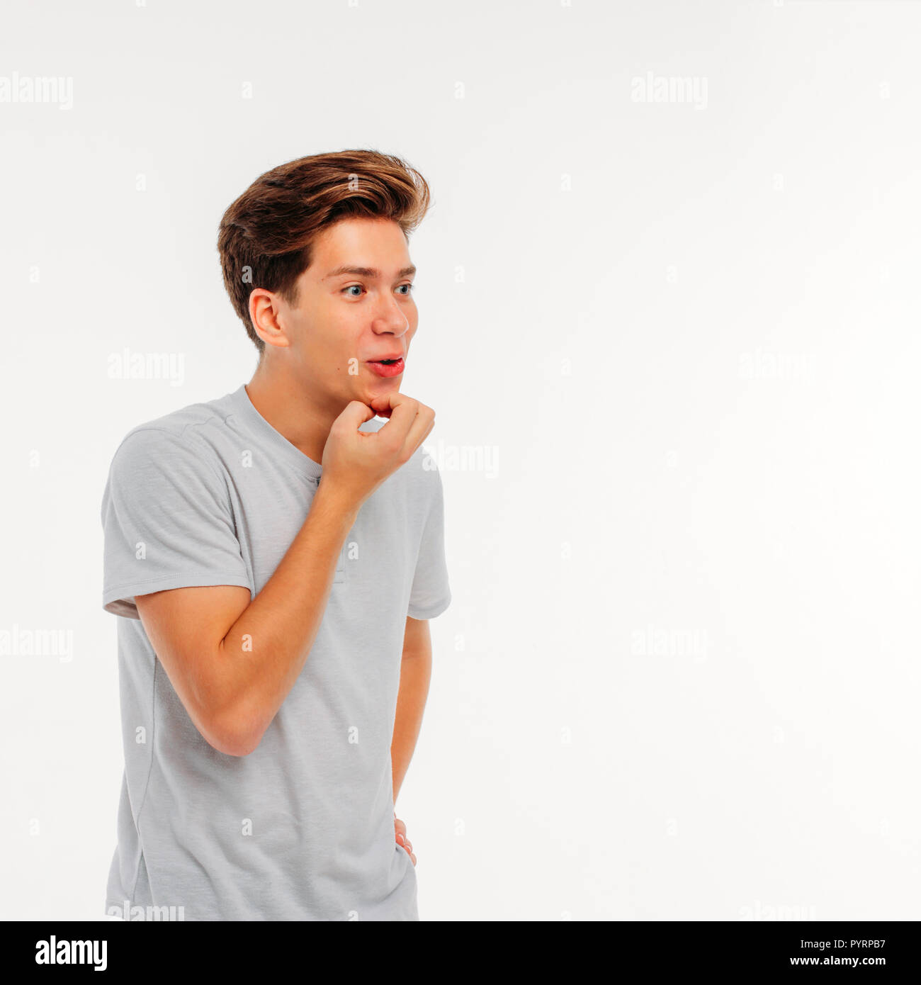 Surprised teenager student on white background Stock Photo - Alamy