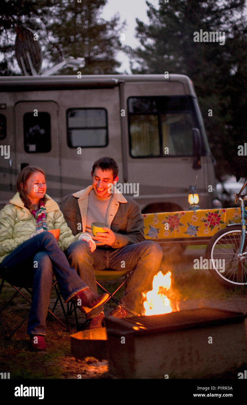Two couples sitting campfire hi-res stock photography and images - Alamy