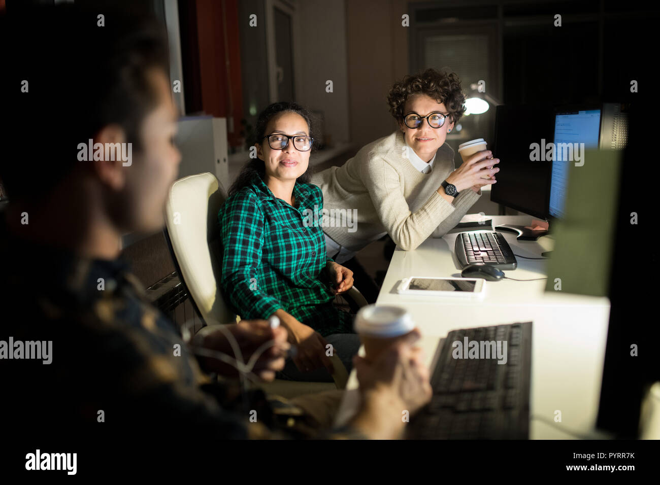 Group of Young People Working at Night Stock Photo - Alamy