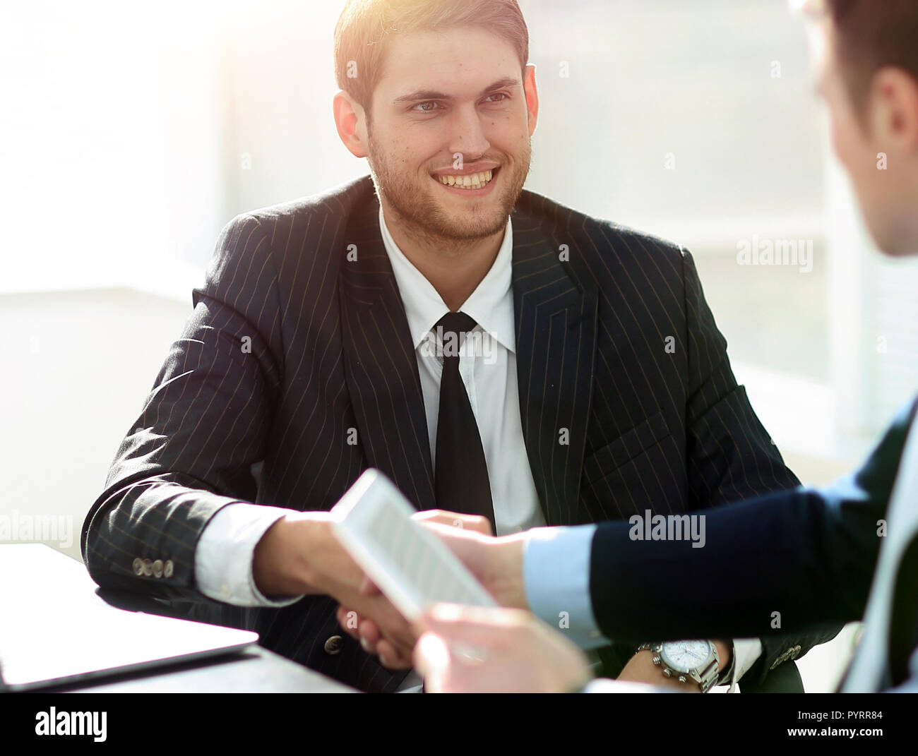 close-up.side view.the handshake business partners at your Desk Stock ...