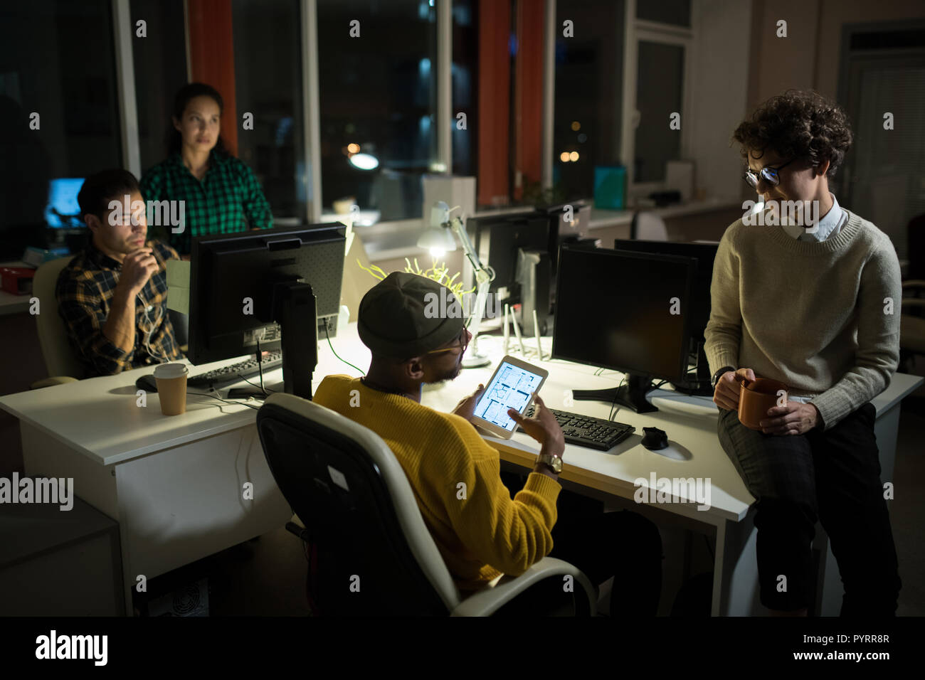 Young People Working Late Stock Photo - Alamy