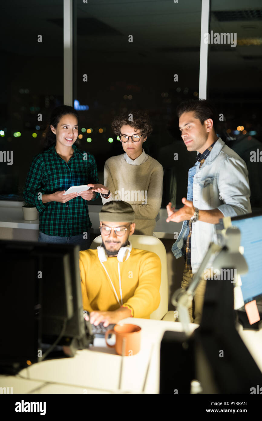 Team Discussing Project at Night Stock Photo - Alamy