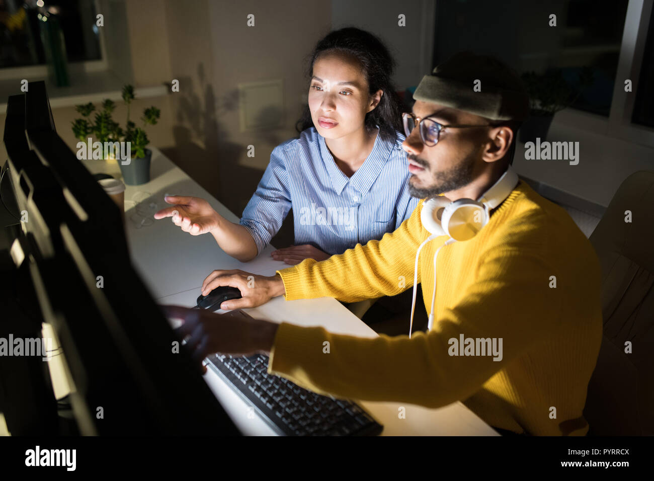 Colleagues Finishing Project at Night Stock Photo - Alamy