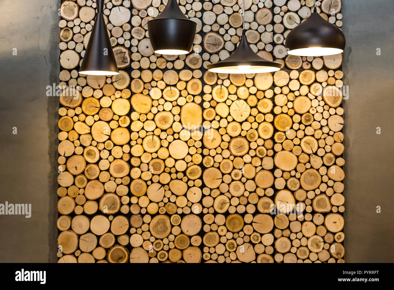 Wall with wooden decorative panels. Front view. Lights of four lamps ...