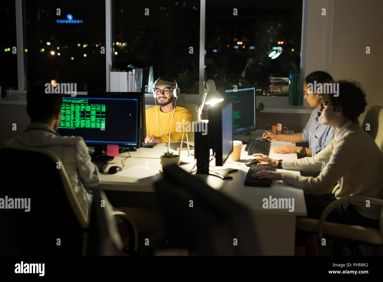 Group of Computer Programmers Coding at Night Stock Photo - Alamy