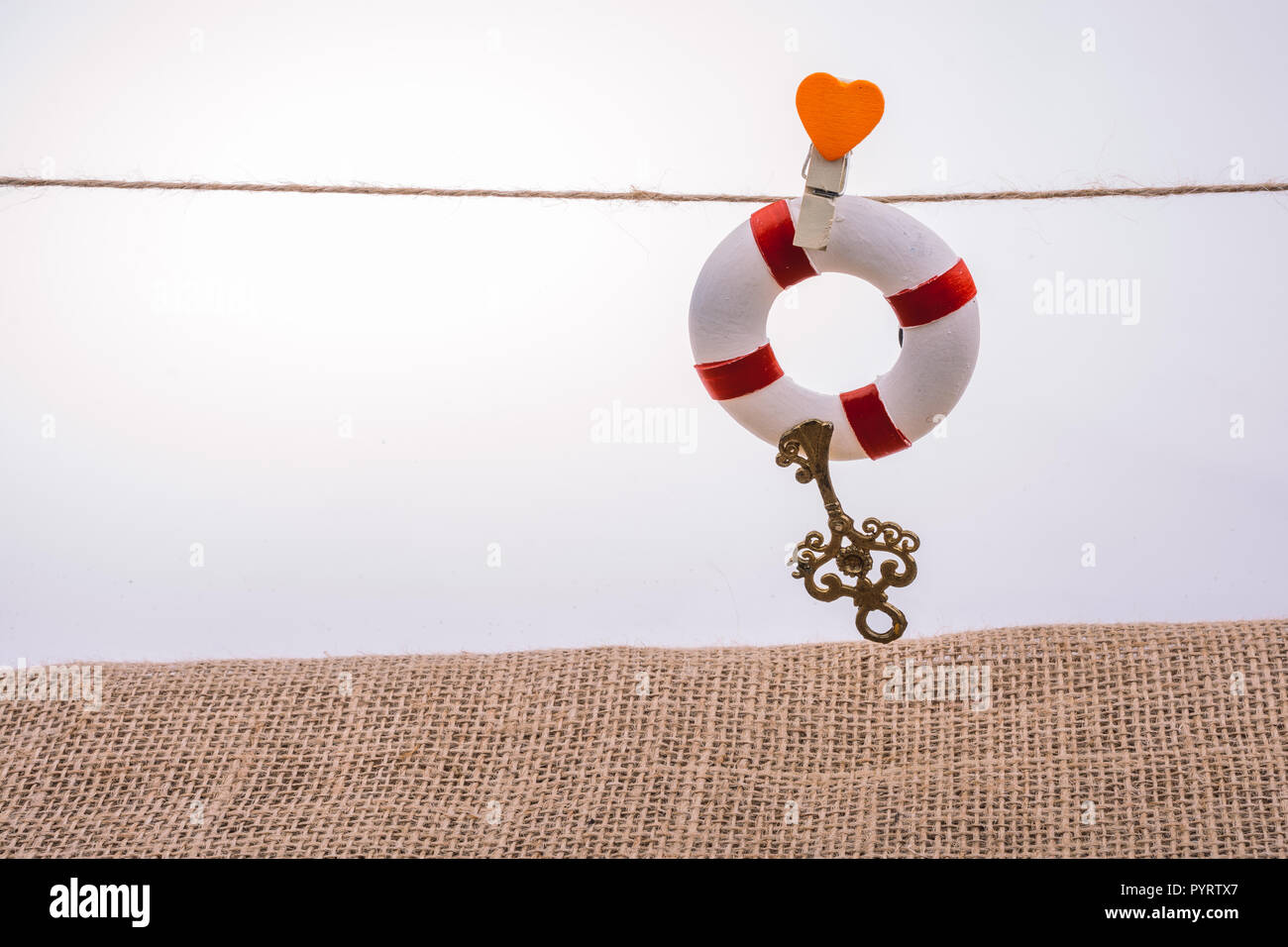 Life preserver attached to a string with heart icon Stock Photo - Alamy