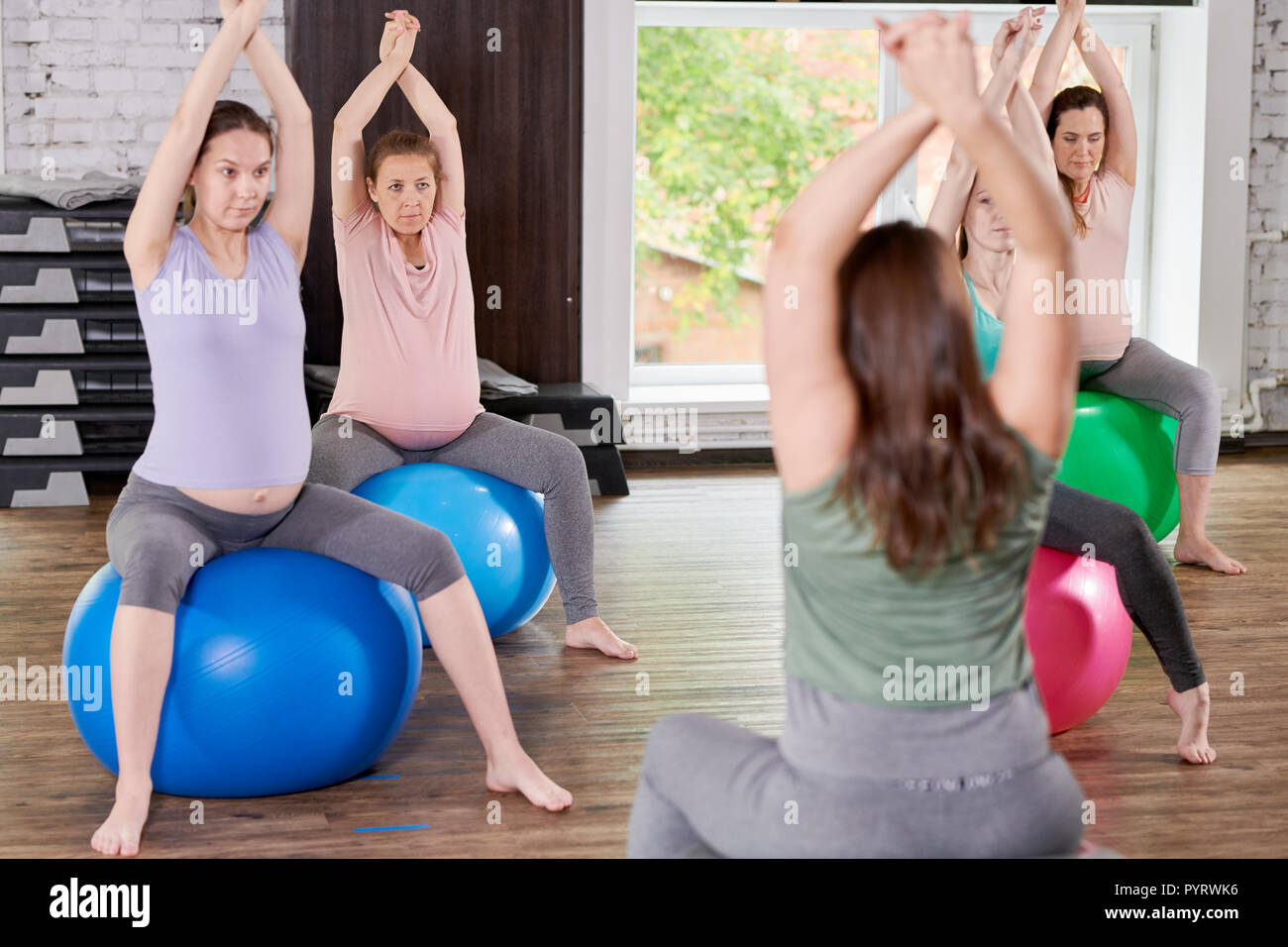 Group of pregnant women exercising hi-res stock photography and images ...